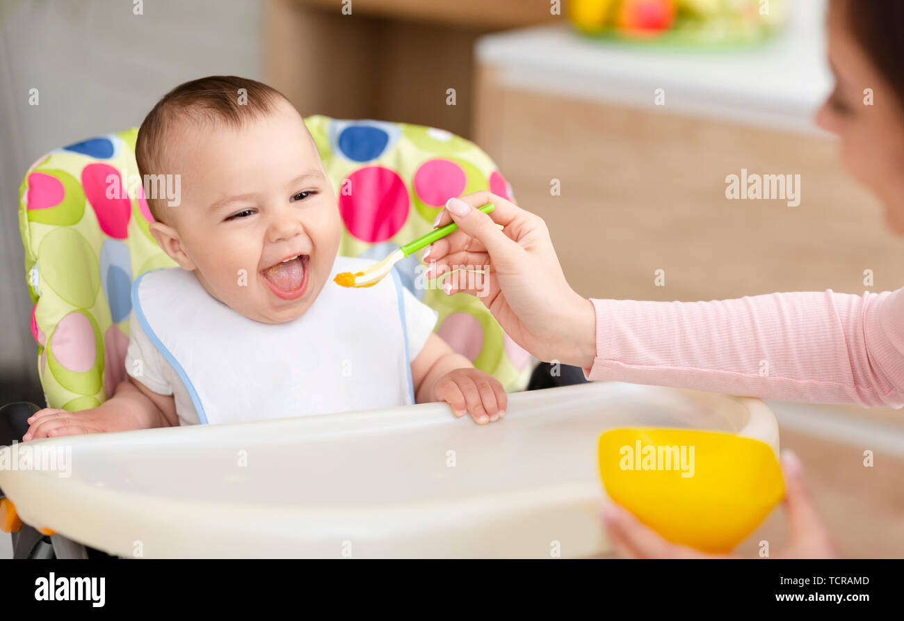 Mother giving healthy food to her adorable baby child Stock Photo - Alamy