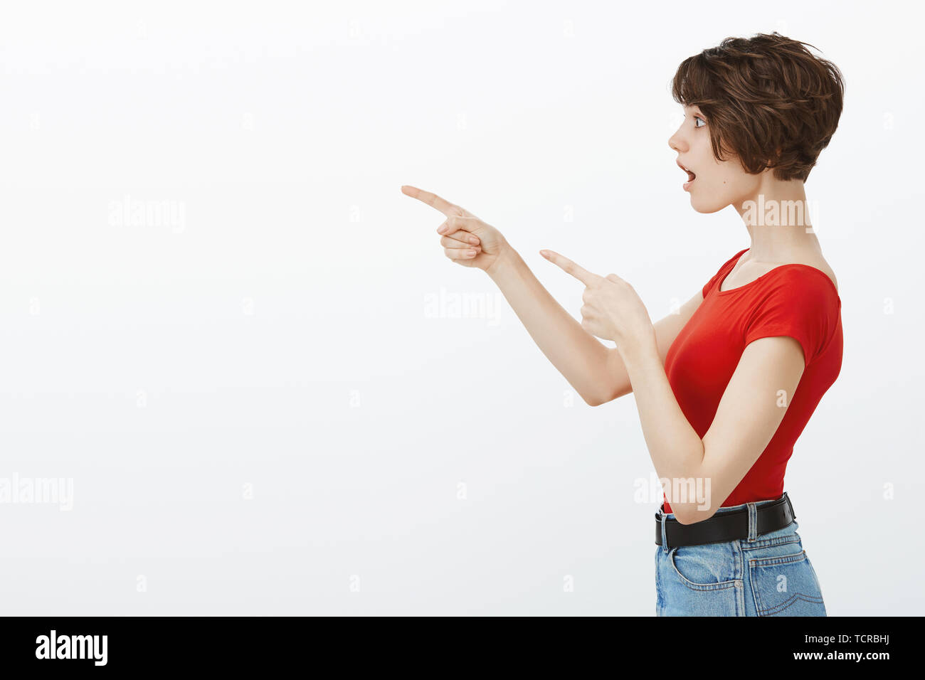 Profile shot shocked surprised attractive woman short pixie haircut red ...