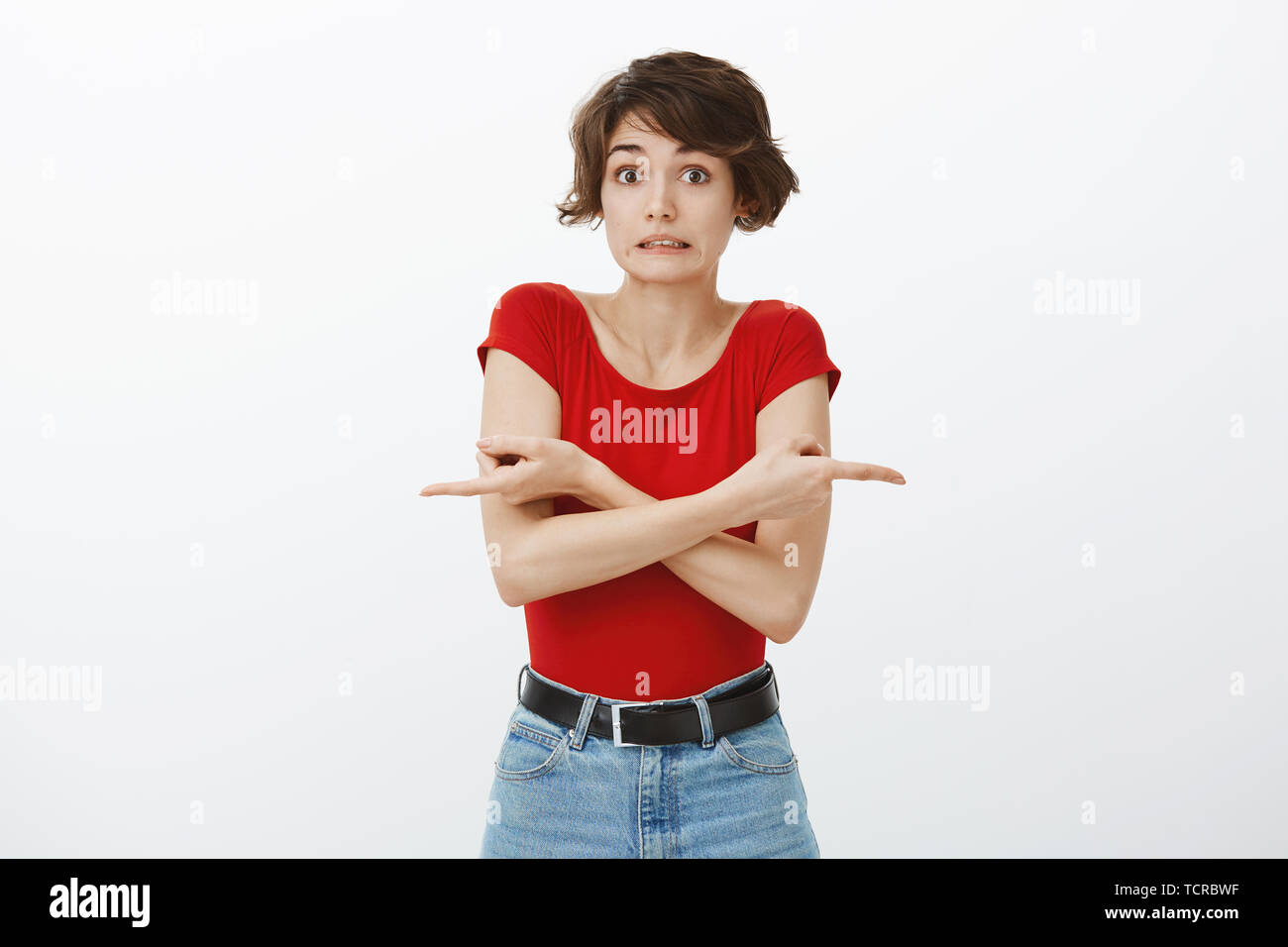 Silly awkward confused attractive woman short haircut cross arms ...