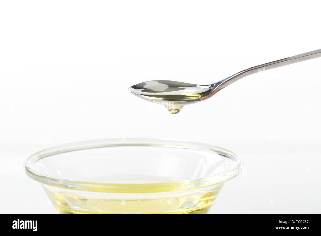 Spoon and cooking oil Stock Photo - Alamy