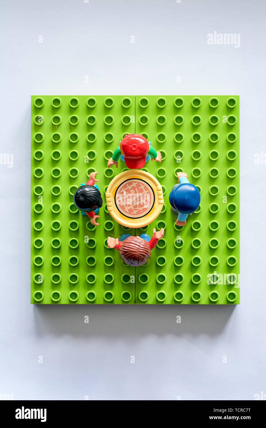 Studio daylight shooting of Lego people around the table, combine from ...