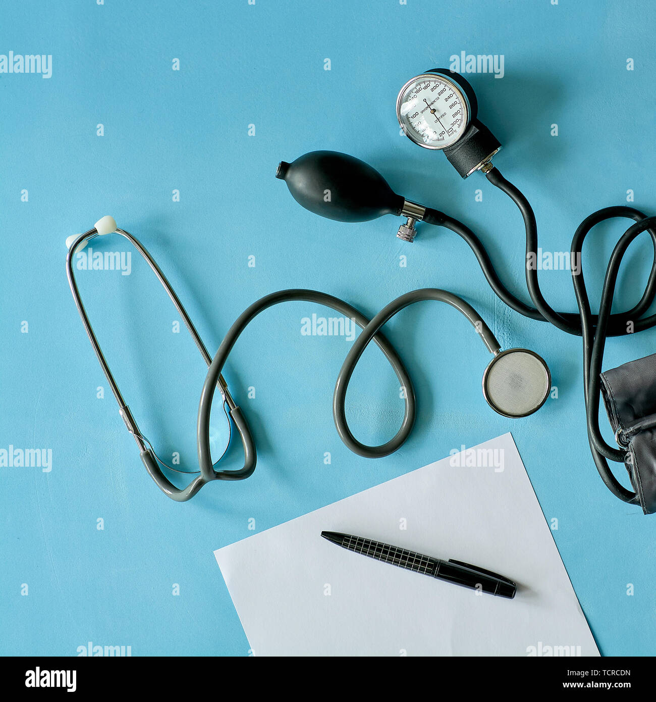 White sheet paper with black pen and phonendoscope stethoscope ...