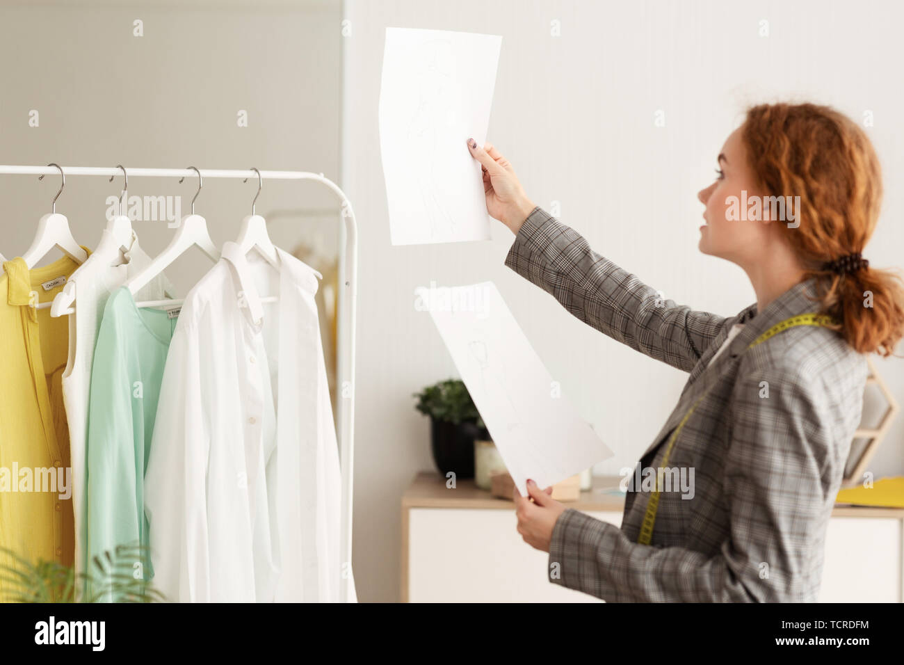 Young Designer Checking And Comparing Sketches On Papers Stock Photo ...