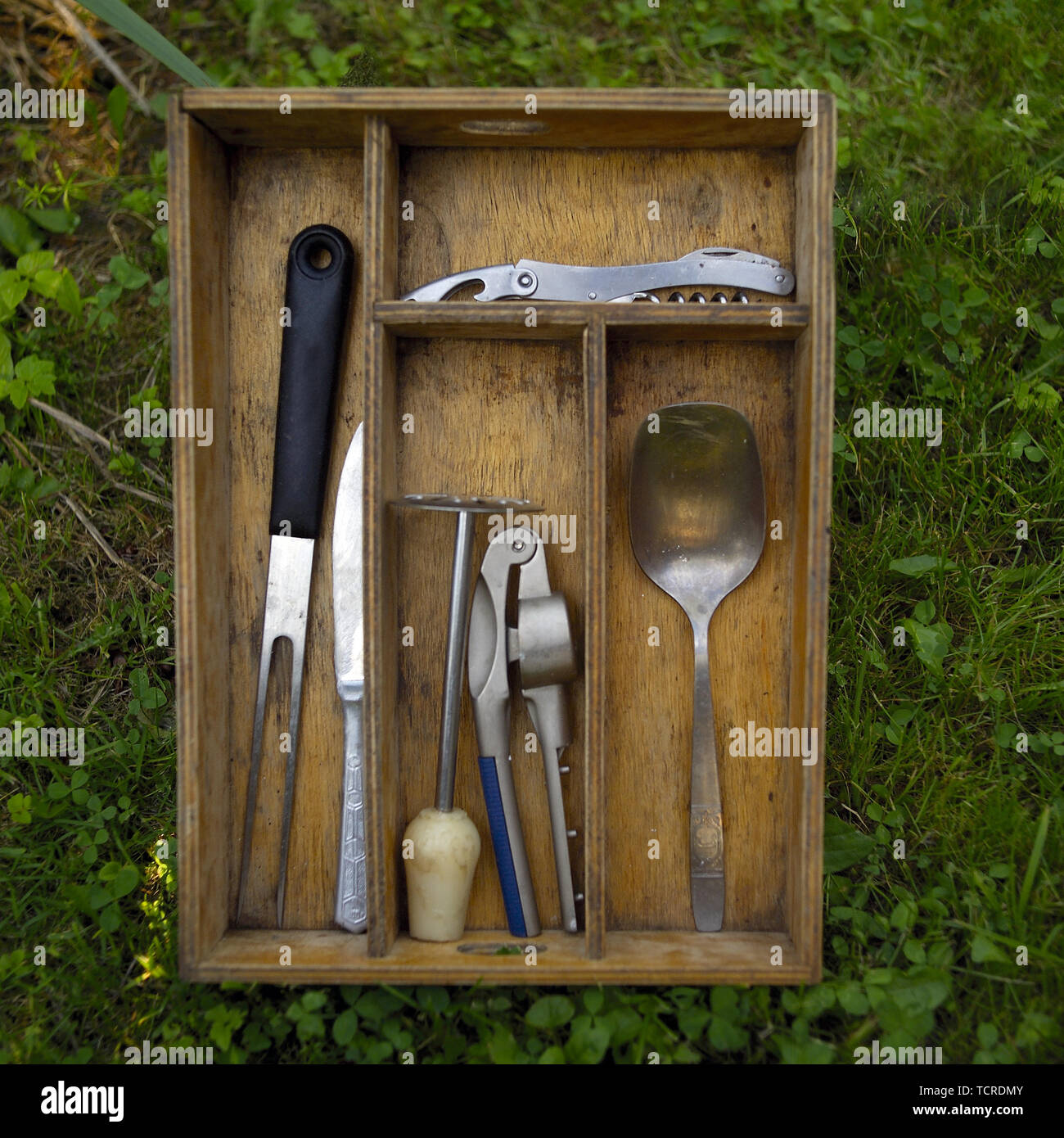 Wooden box with various kitchen utensils placed on the ground Stock ...