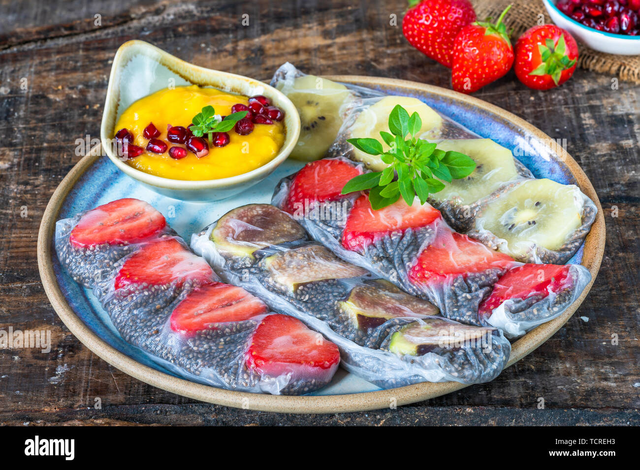 Chia seeds and fruit rice paper rolls with mango dipping sauce Stock ...