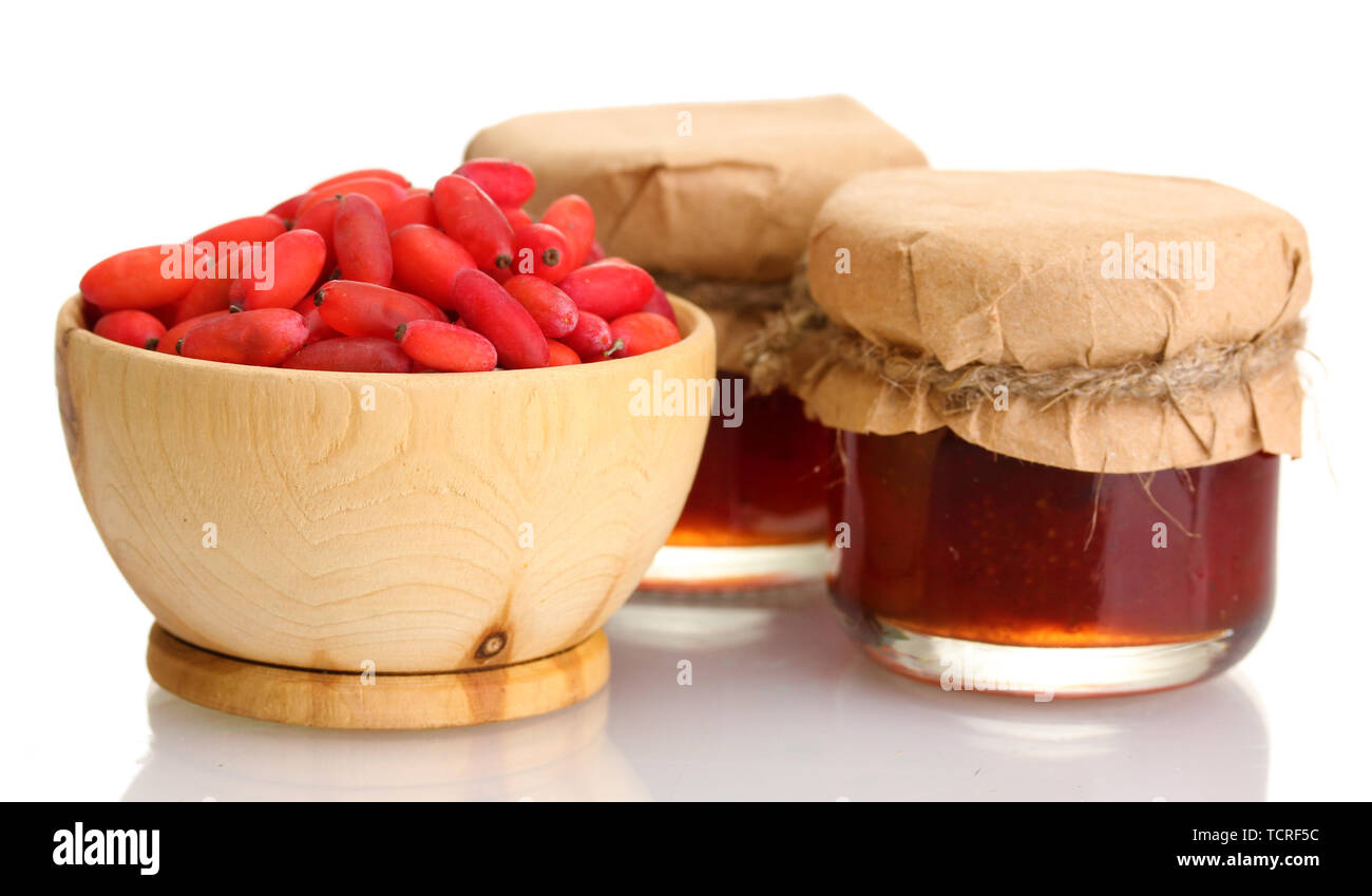 ripe barberries in wooden bowl and jars of jam isolated white Stock ...