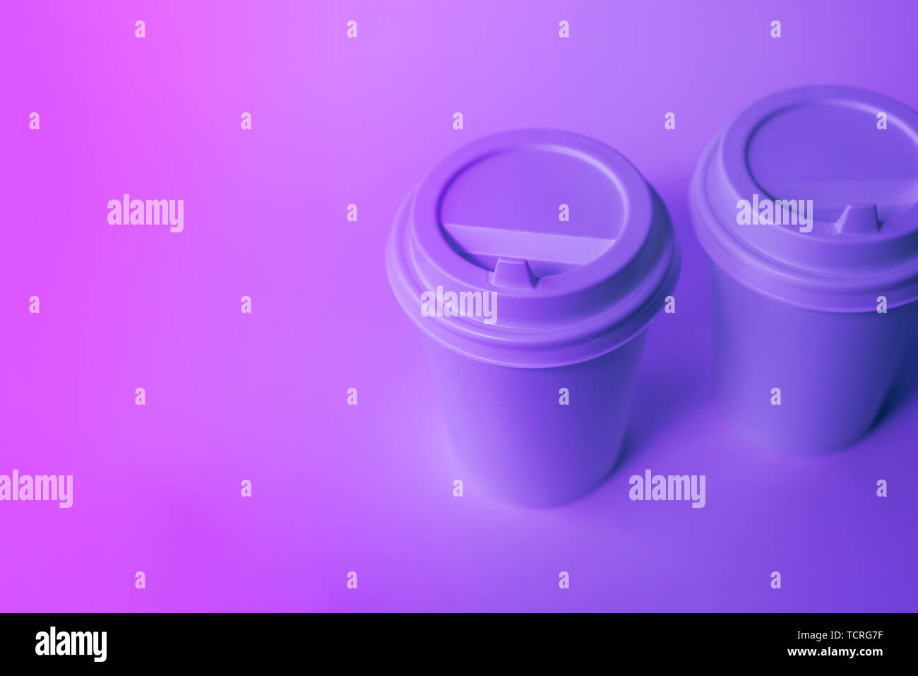 Paper disposable cups in trendy neon light Stock Photo - Alamy