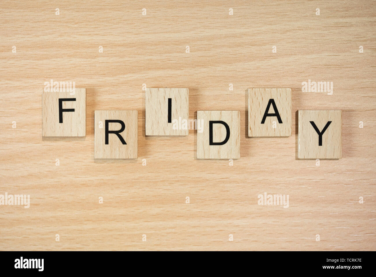 The word Friday, spelt out using wooden tiles on a wood effect ...
