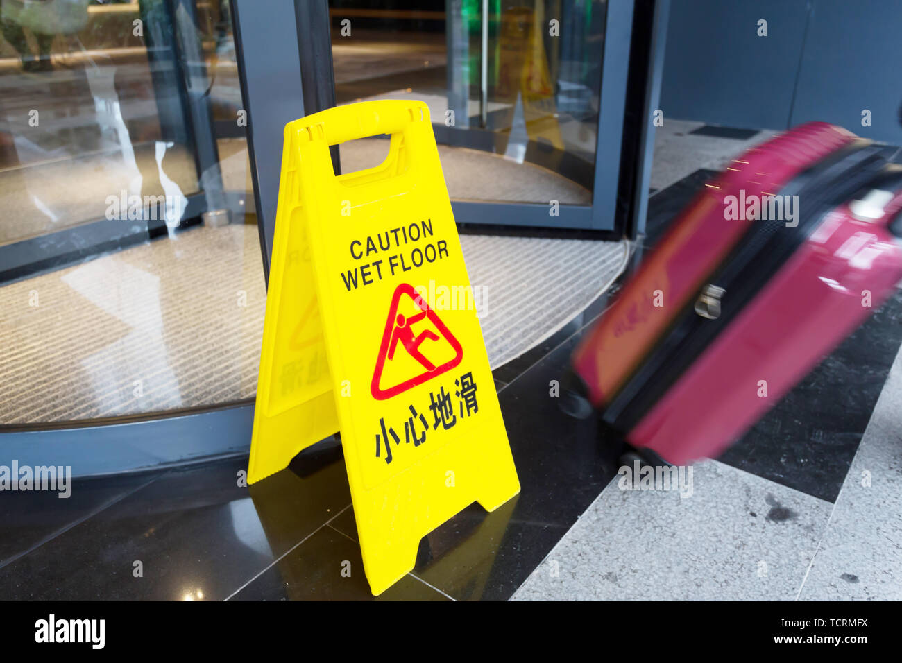 Sign showing warning of caution wet floor Stock Photo - Alamy