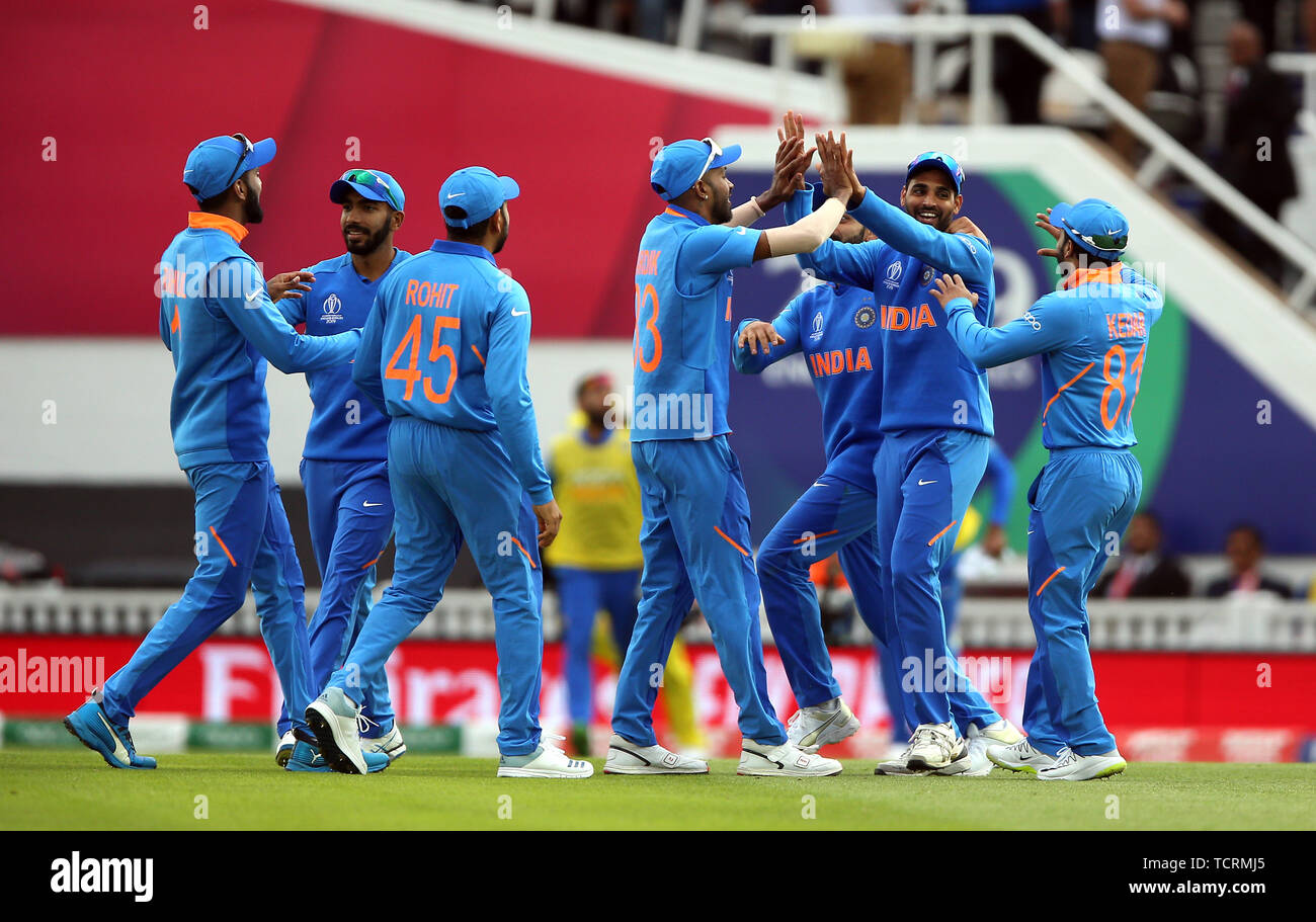 India players celebrate taking the wicket of Australia's David Warner ...