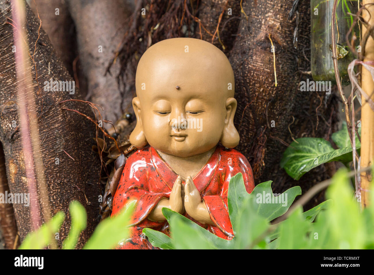 A statue of a little monk Stock Photo - Alamy