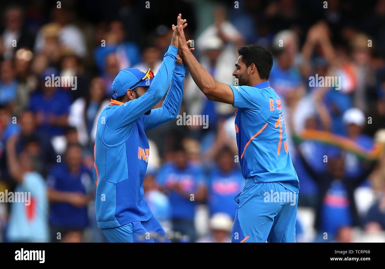 India's Bhuvneshwar Kumar (right) celebrates taking the wicket of ...