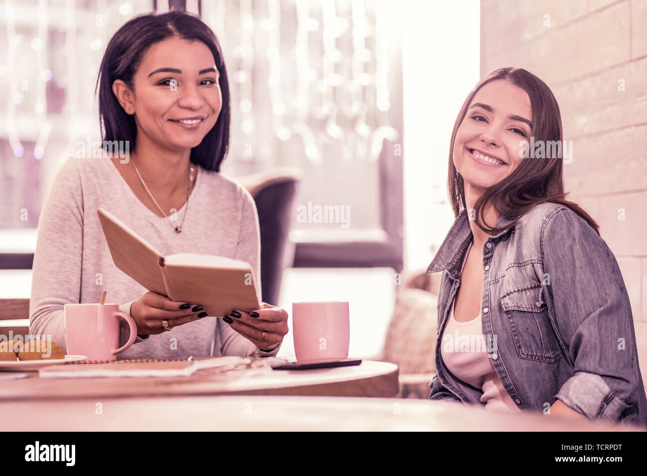 Two best friends having their traditional weekend meeting in favorite ...