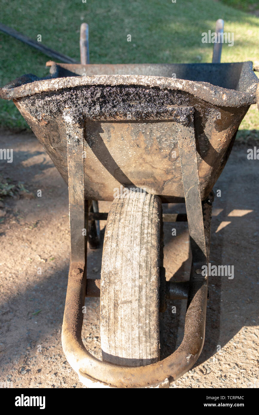 A close up front view of a old used work wheel barrow Stock Photo - Alamy