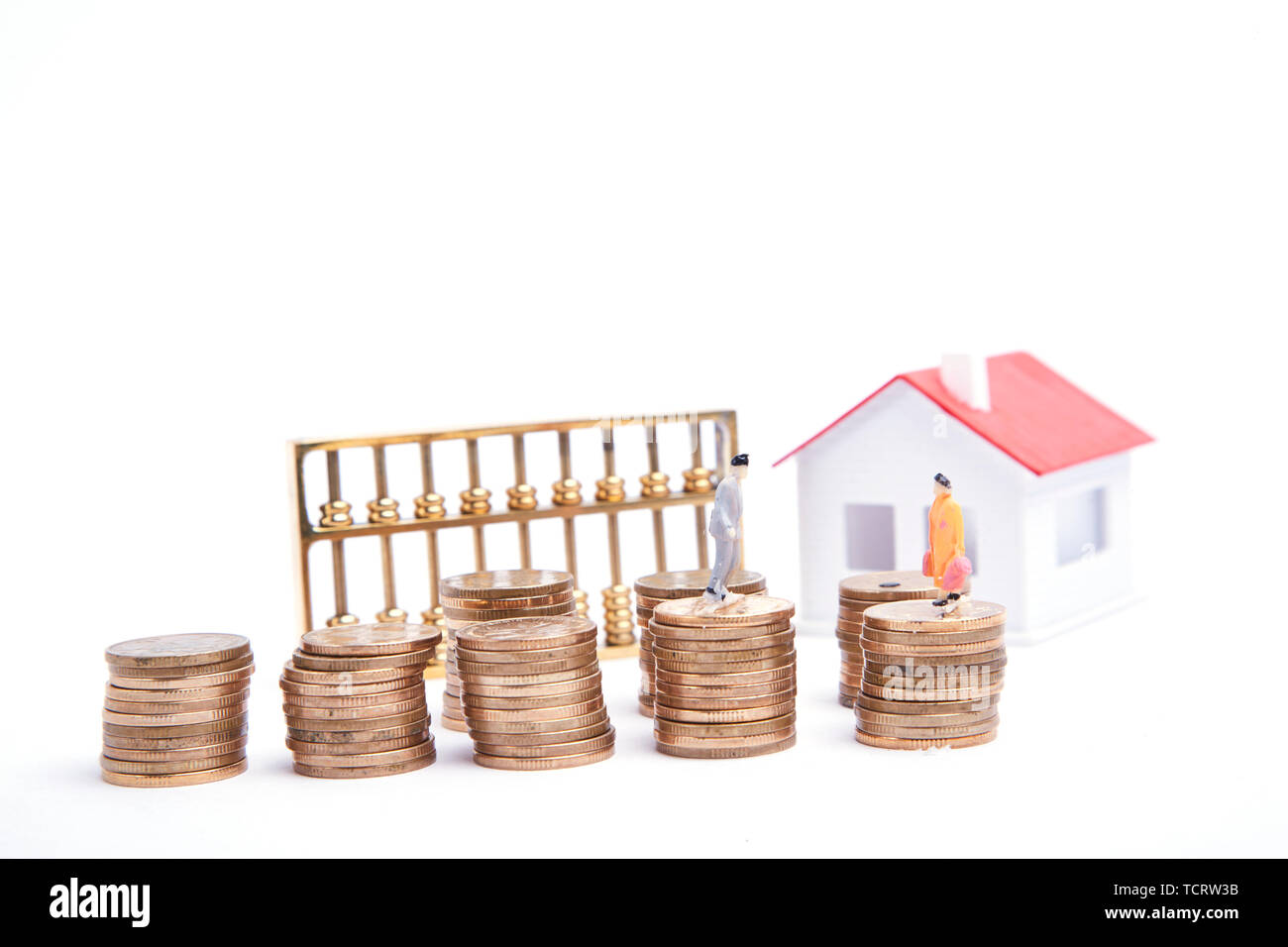 Coin house model and couple on white background Stock Photo - Alamy