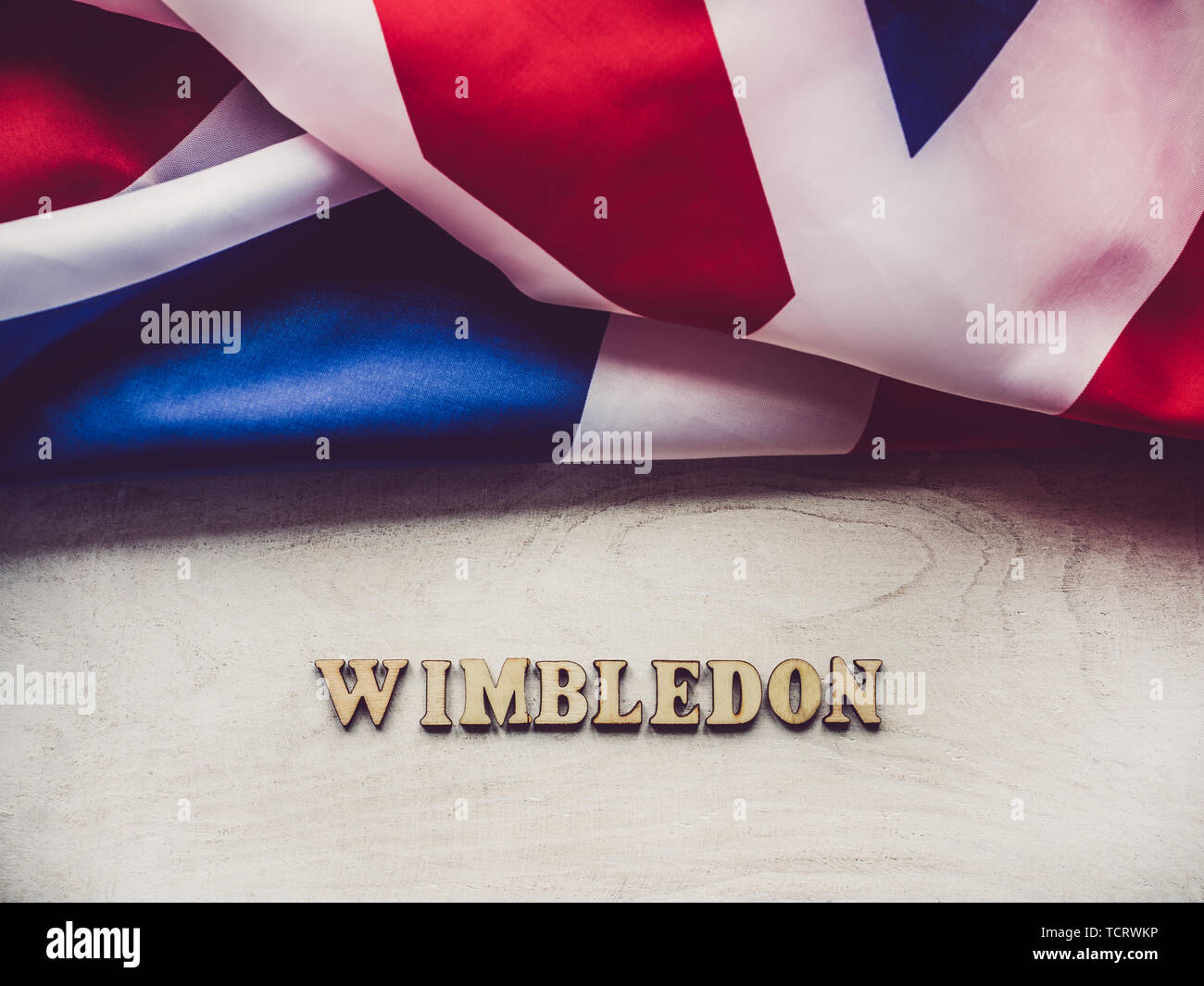 WIMBLEDON. Wooden, unpainted letters on a white table. Close-up, top ...