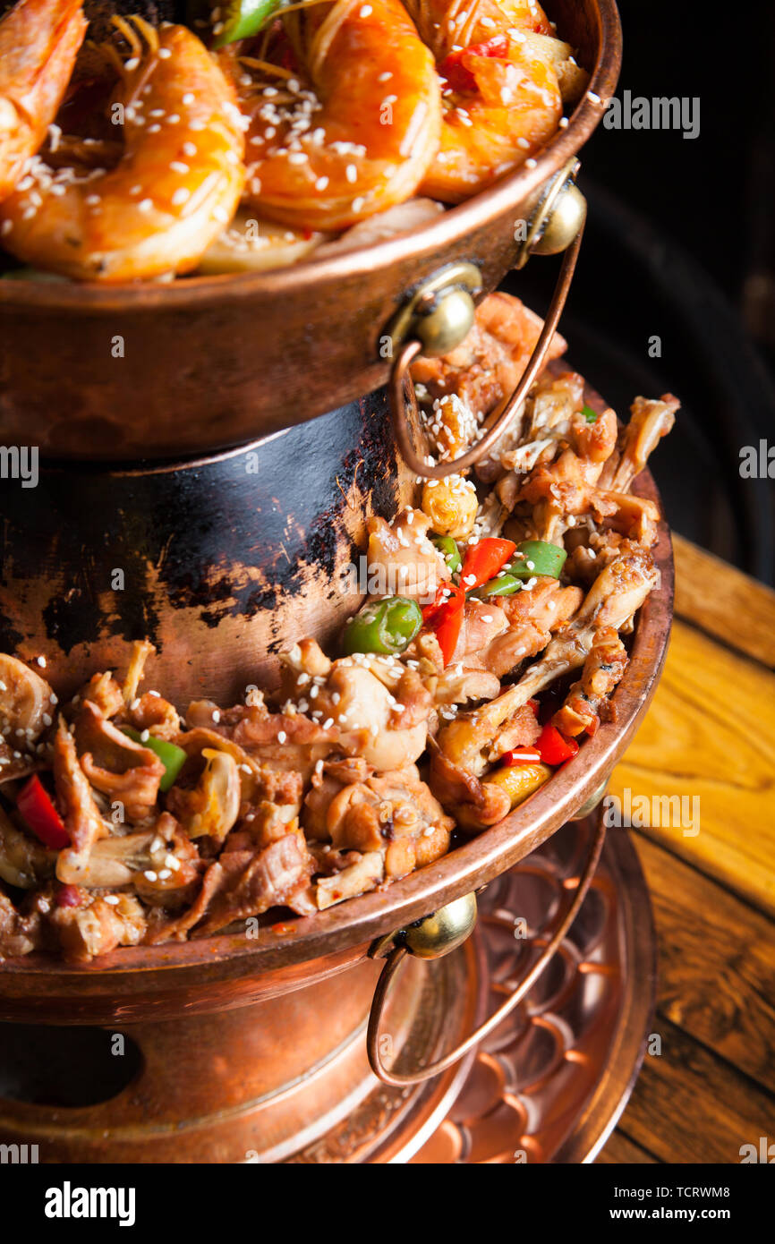 Charcoal fire frog pot field chicken meal Stock Photo - Alamy