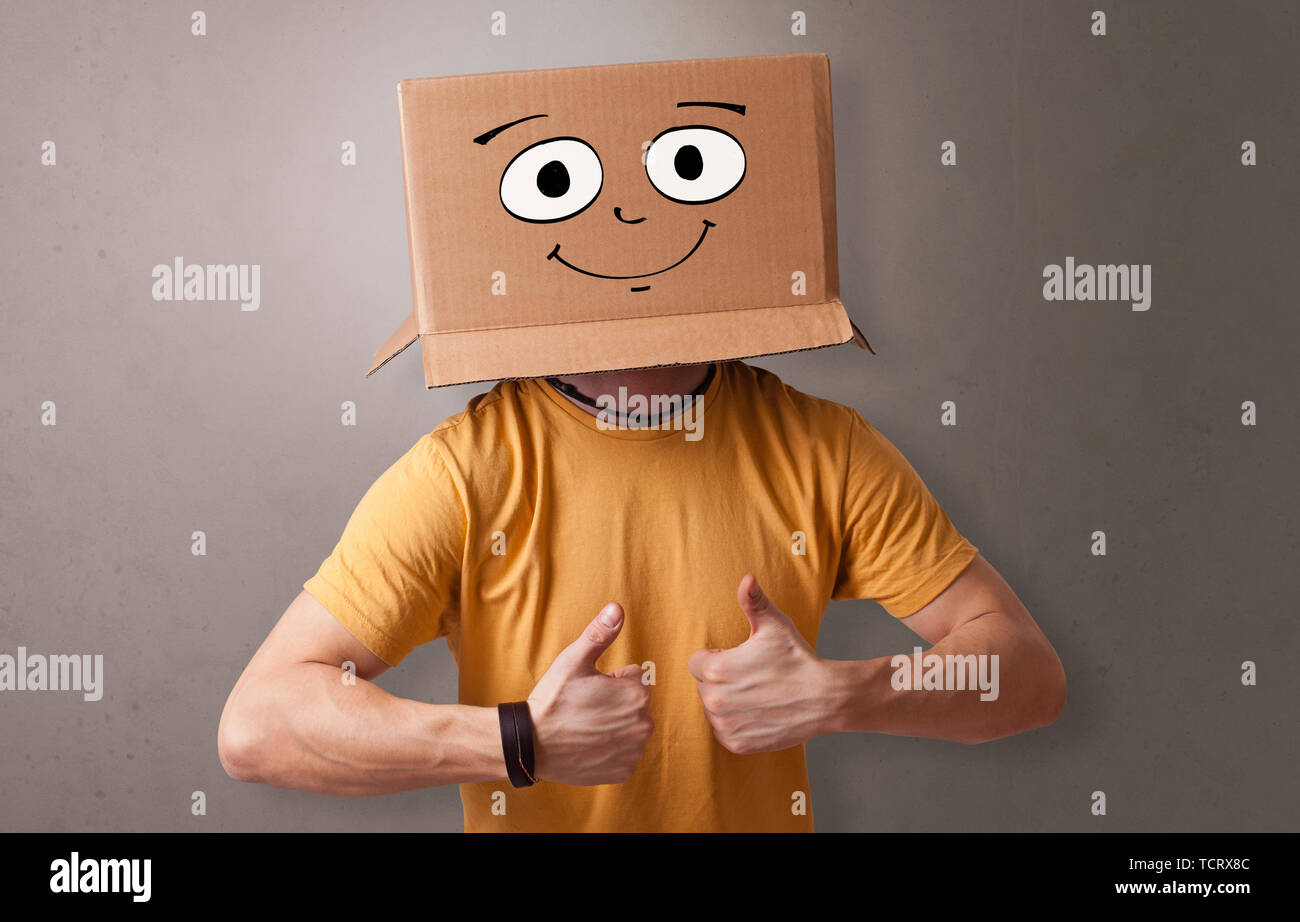 Young boy standing and gesturing with a cardboard box on his head Stock ...