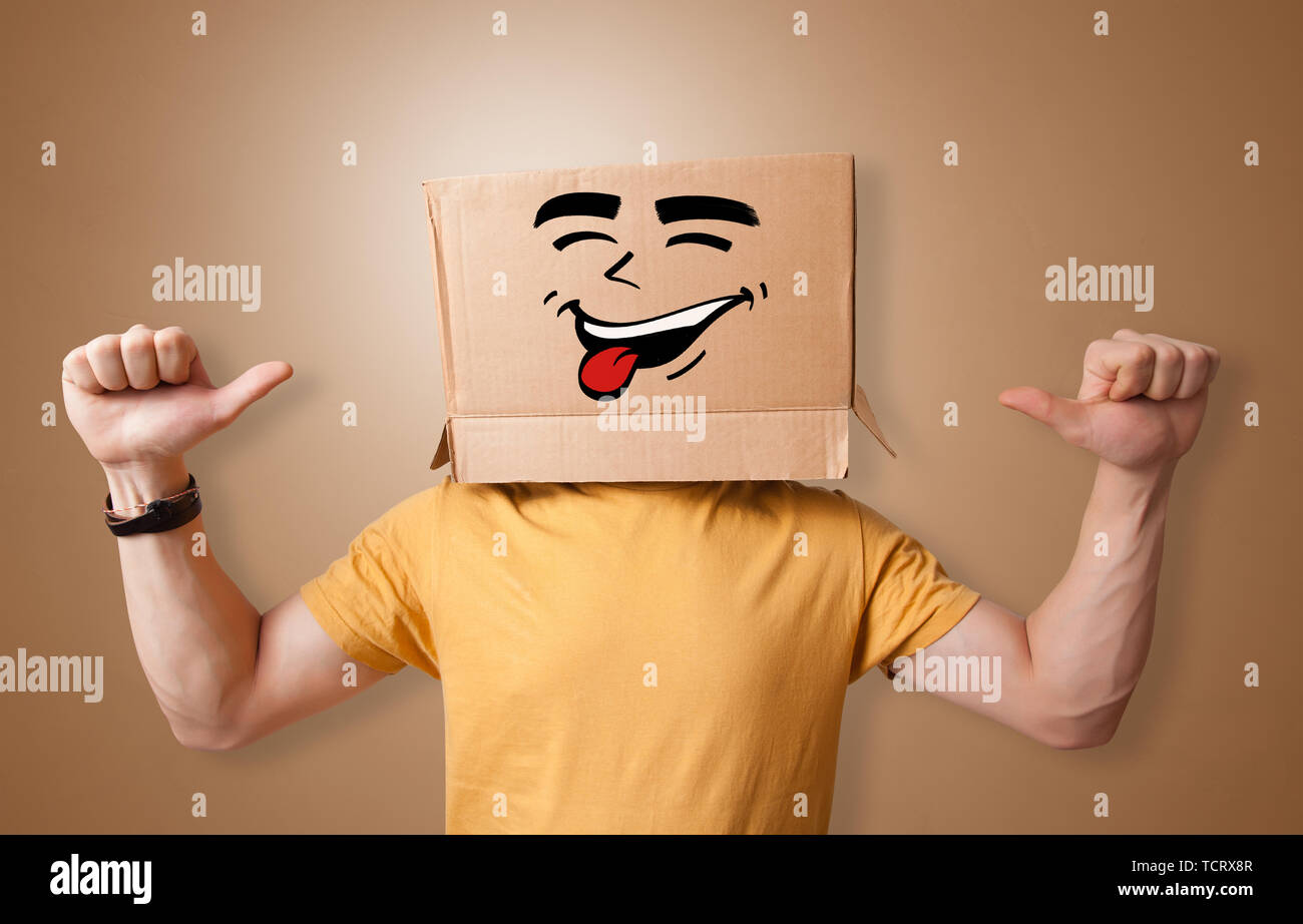 Young boy standing and gesturing with a cardboard box on his head Stock ...