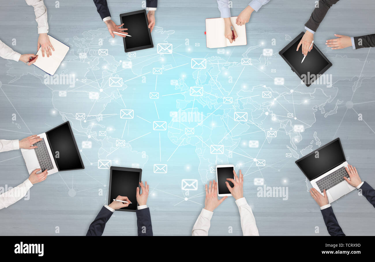 Group of people with devices in hands working in team on tablets ...