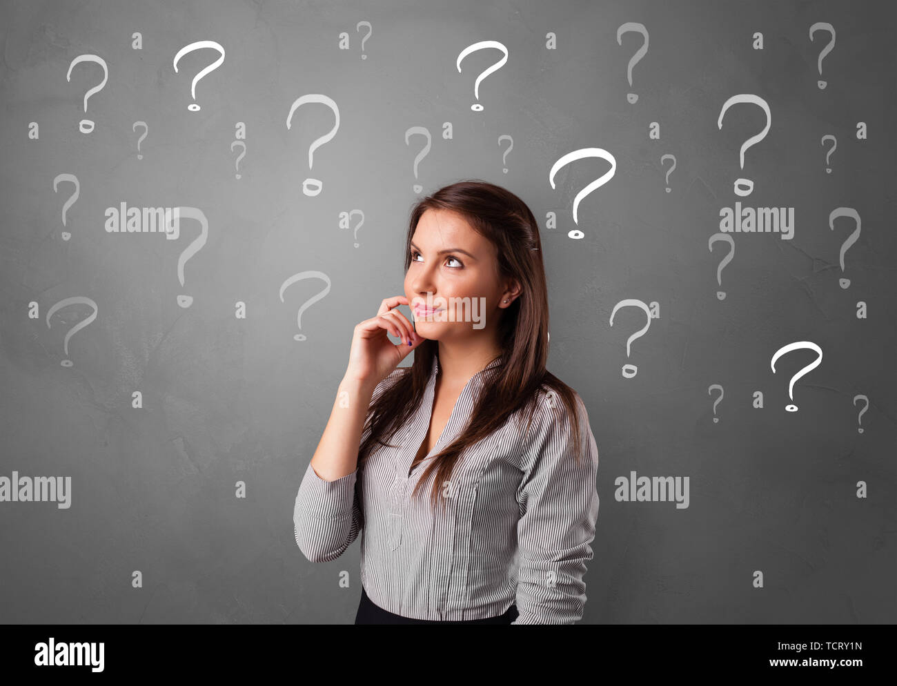 Person with question marks around face Stock Photo - Alamy