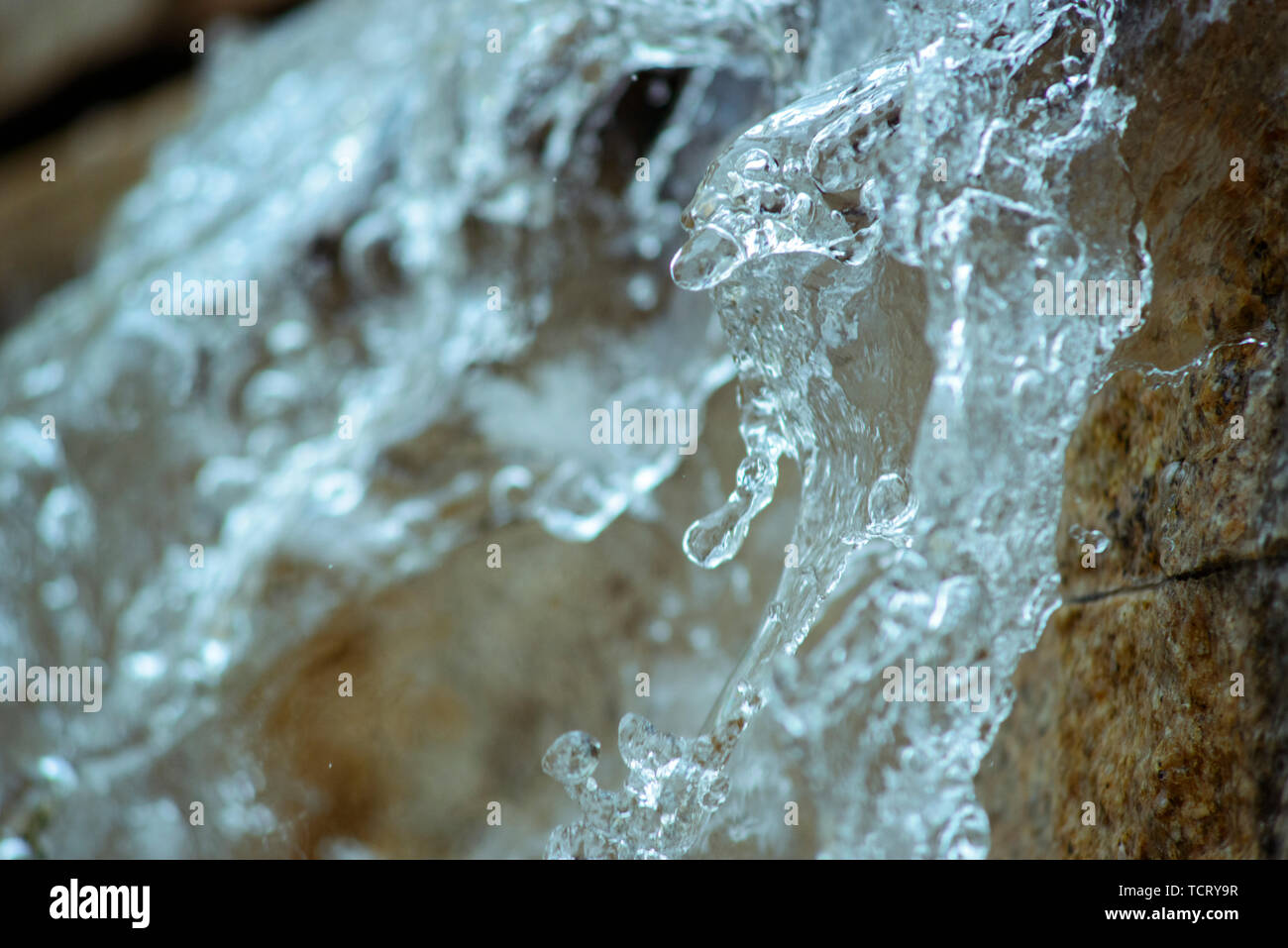 A bead of water formed by flowing water Stock Photo - Alamy
