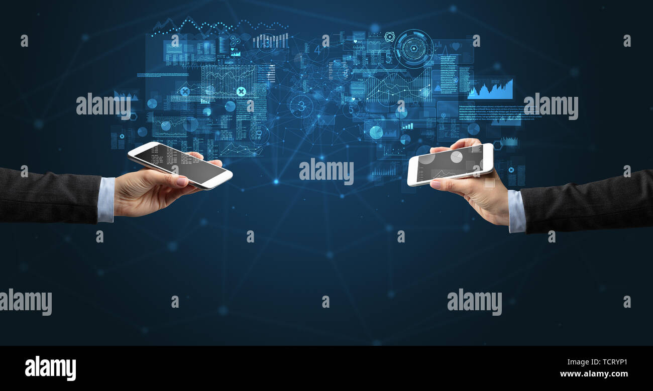 Close up of two hands holding smartphones to sync business data Stock ...