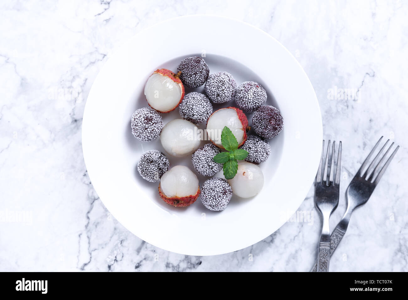 Frozen plum and fresh lychee Stock Photo - Alamy