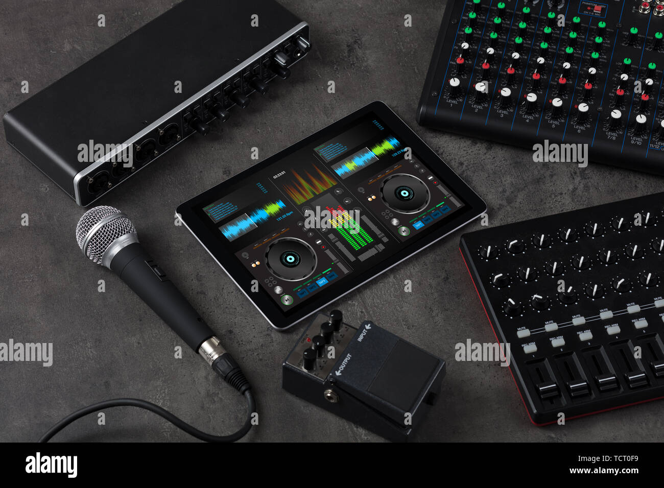 Mixing music on tablet with electronic music instruments concept Stock ...