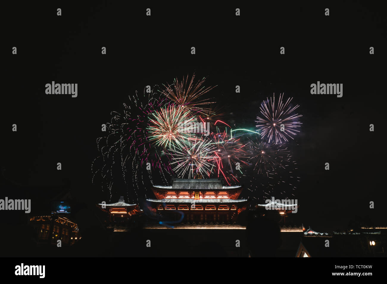 Fireworks blooming above Chinese ancient buildings Stock Photo - Alamy