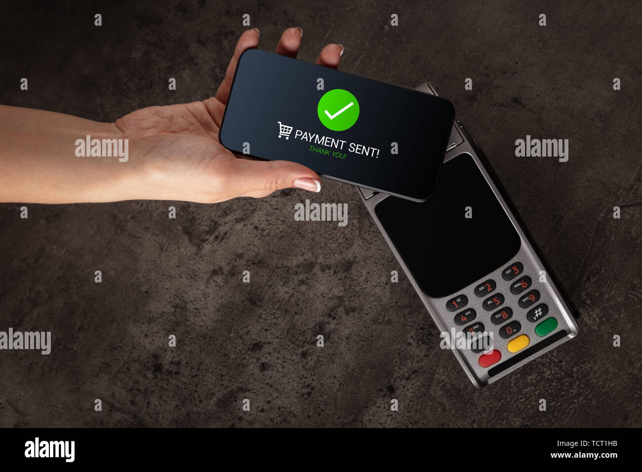 Mobile payment accepted on terminal Stock Photo - Alamy