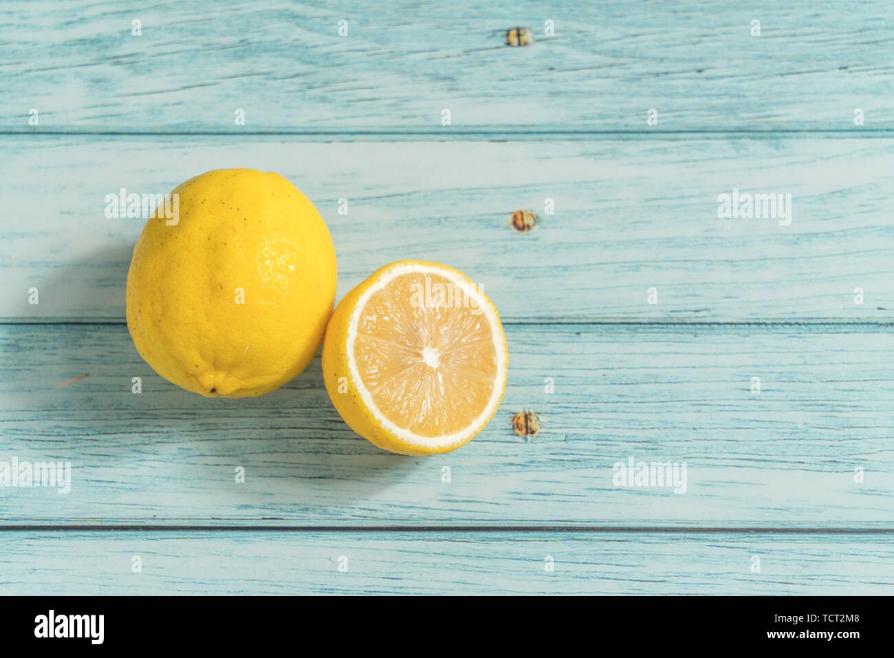 Lemon with teal wood pattern background Stock Photo - Alamy