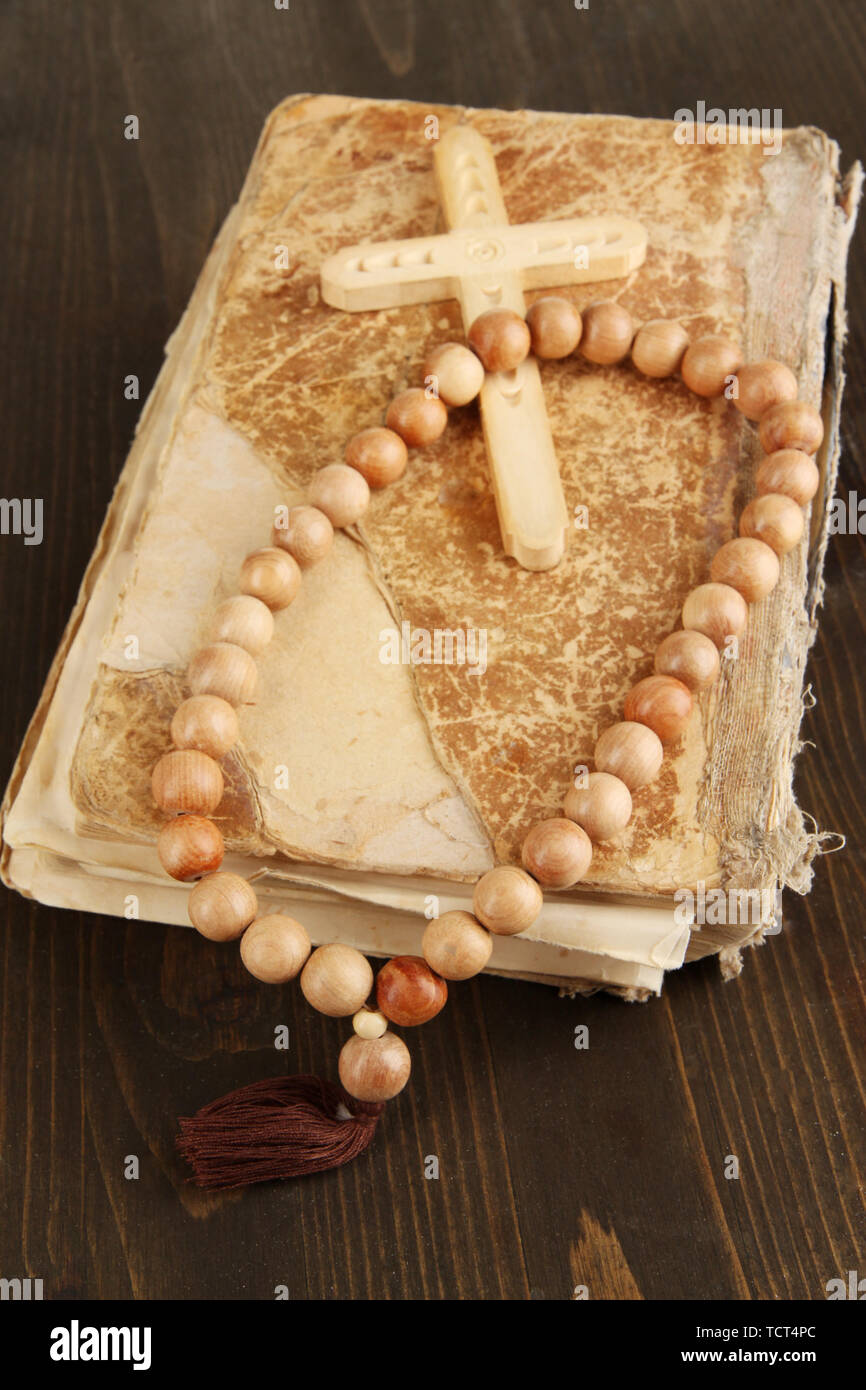 Bible, rosary and cross on wooden table close-up Stock Photo - Alamy