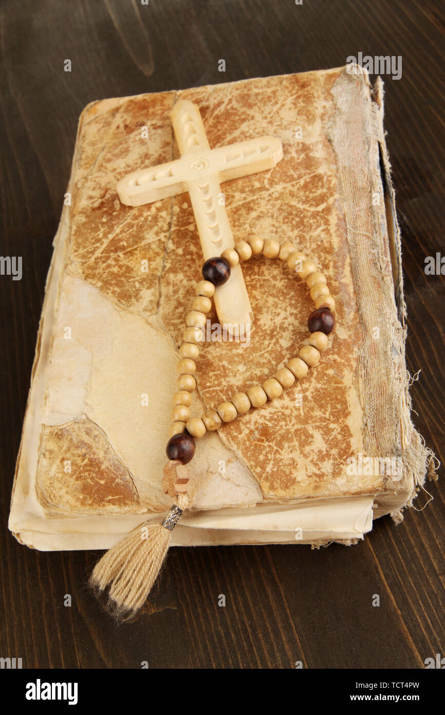 Bible, rosary and cross on wooden table close-up Stock Photo - Alamy