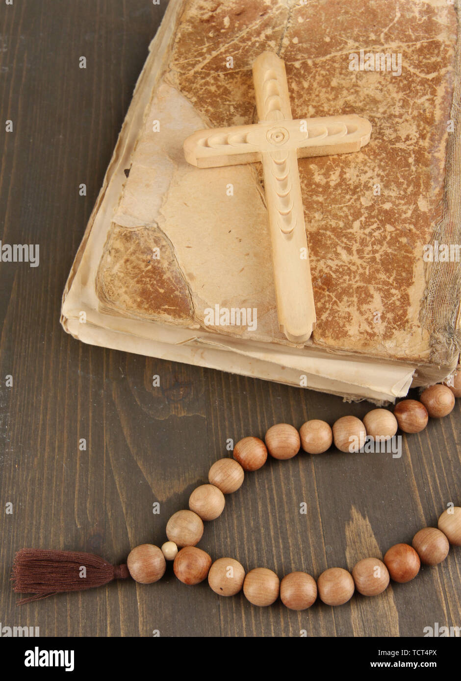 Bible, rosary and cross on wooden table close-up Stock Photo - Alamy