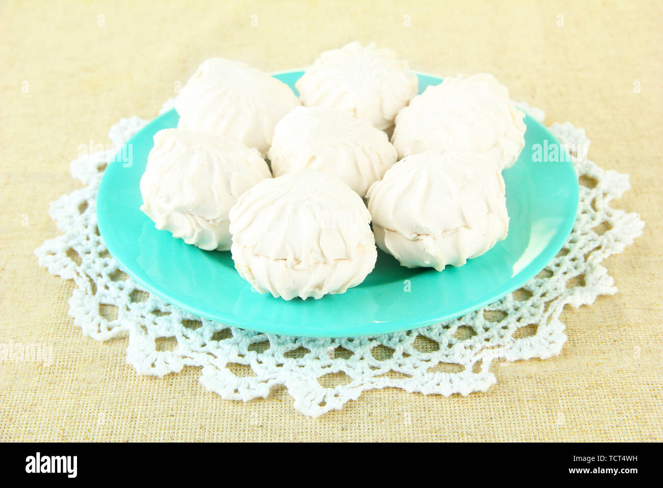 Marshmallows on color plate on light background Stock Photo - Alamy