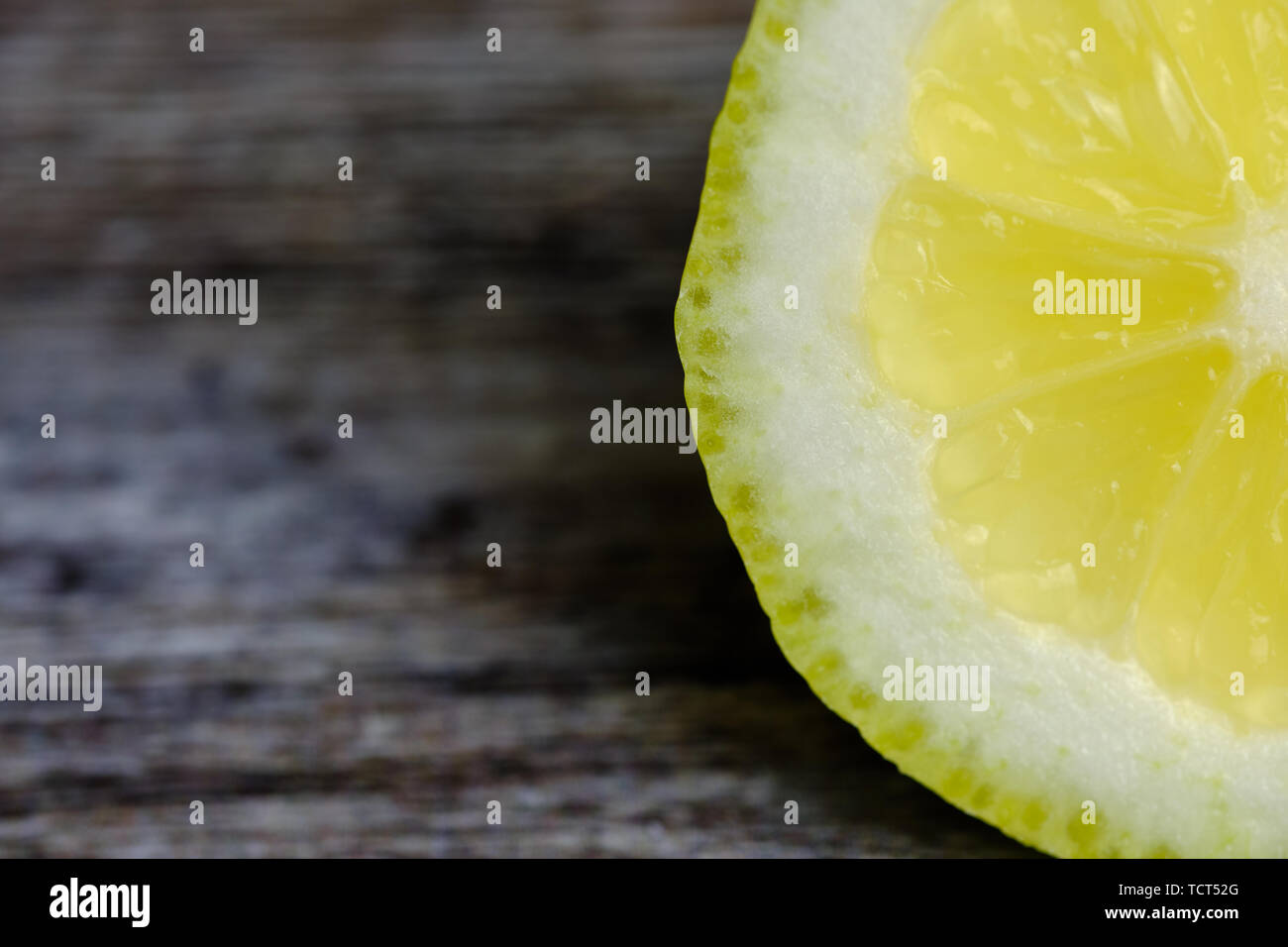 color photo of a lemon part on wooden background with copy space Stock ...