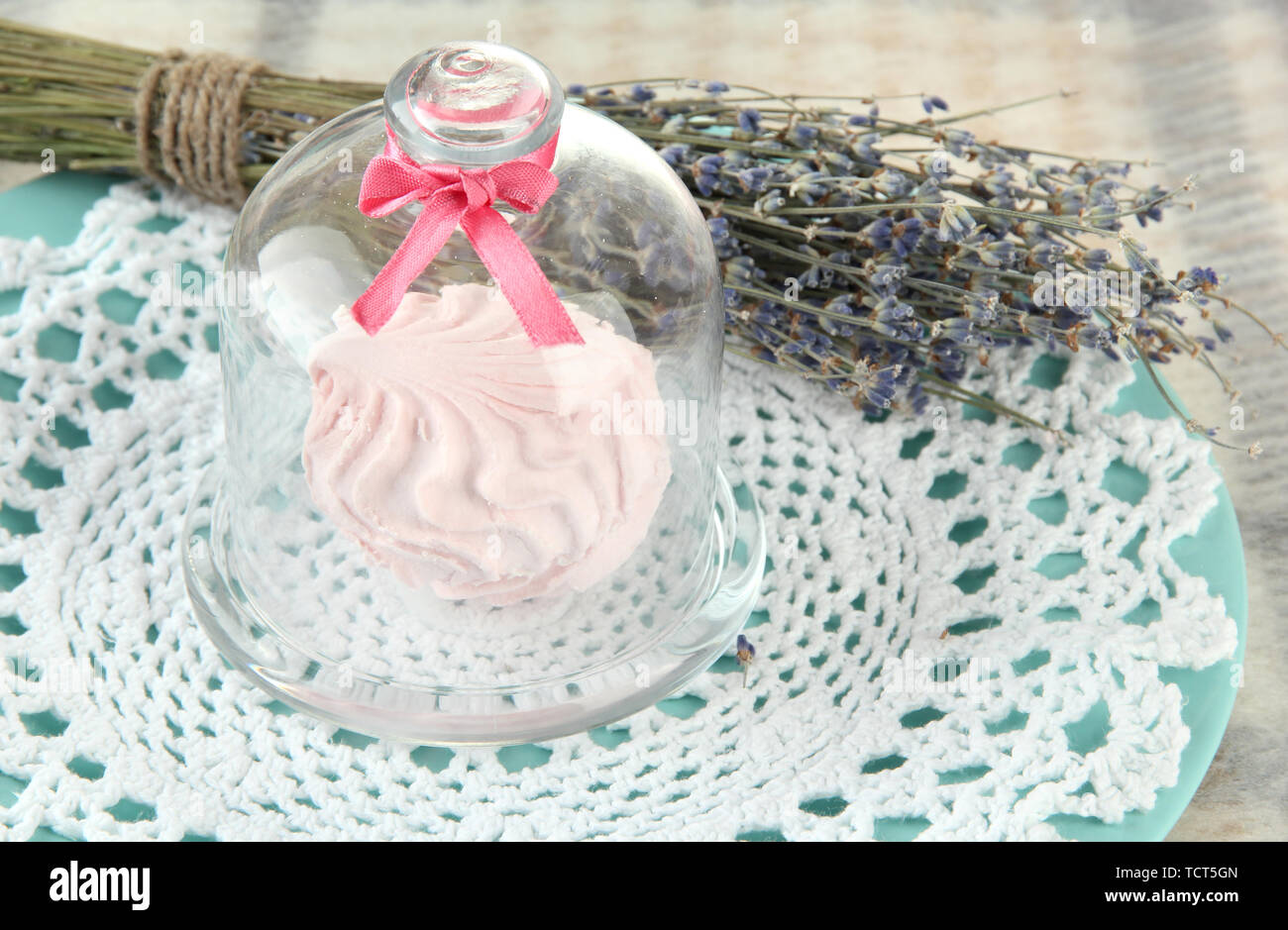 Marshmallows on saucer with transparent cover on light background Stock ...
