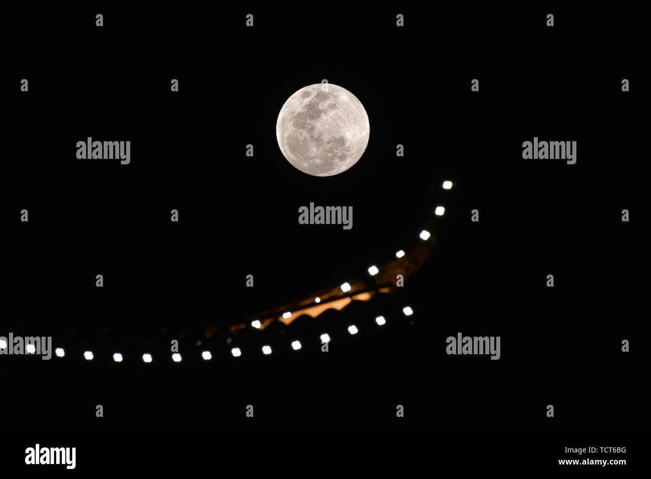 The round moon hangs high in the sky Stock Photo - Alamy