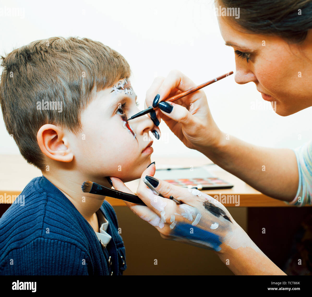little cute child making facepaint on birthday party, zombie Apocalypse ...
