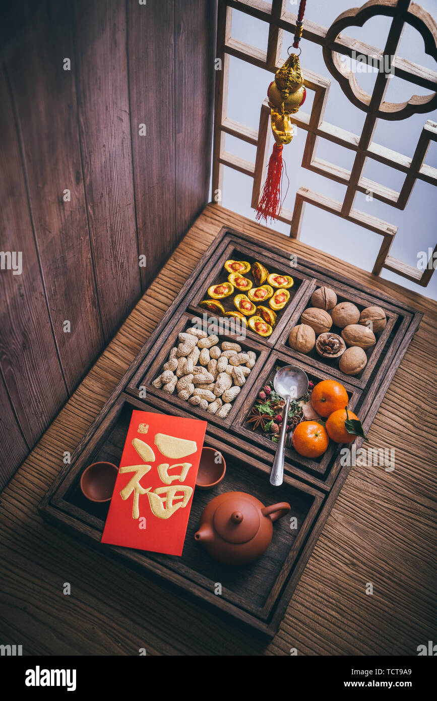 Red envelopes on wooden board table with Chinese elements under red ...