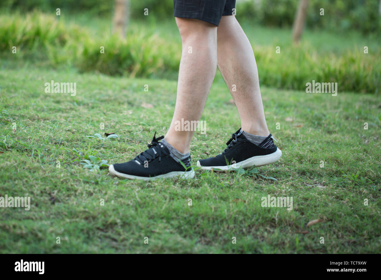 Man running on grass Stock Photo - Alamy