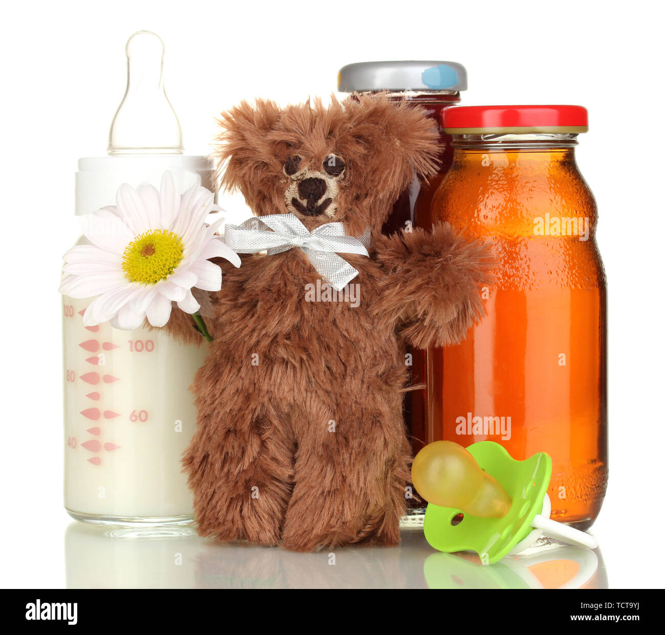 Baby food, bottle of milk and juice with teddy bear isolated on white ...