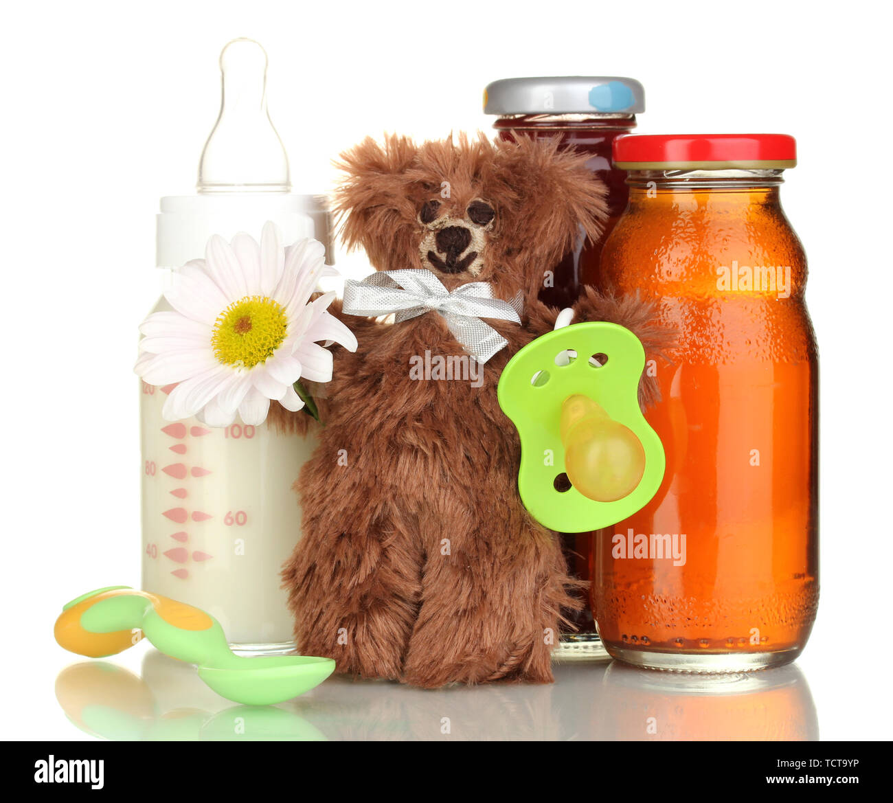 Baby food, bottle of milk and juice with teddy bear isolated on white ...