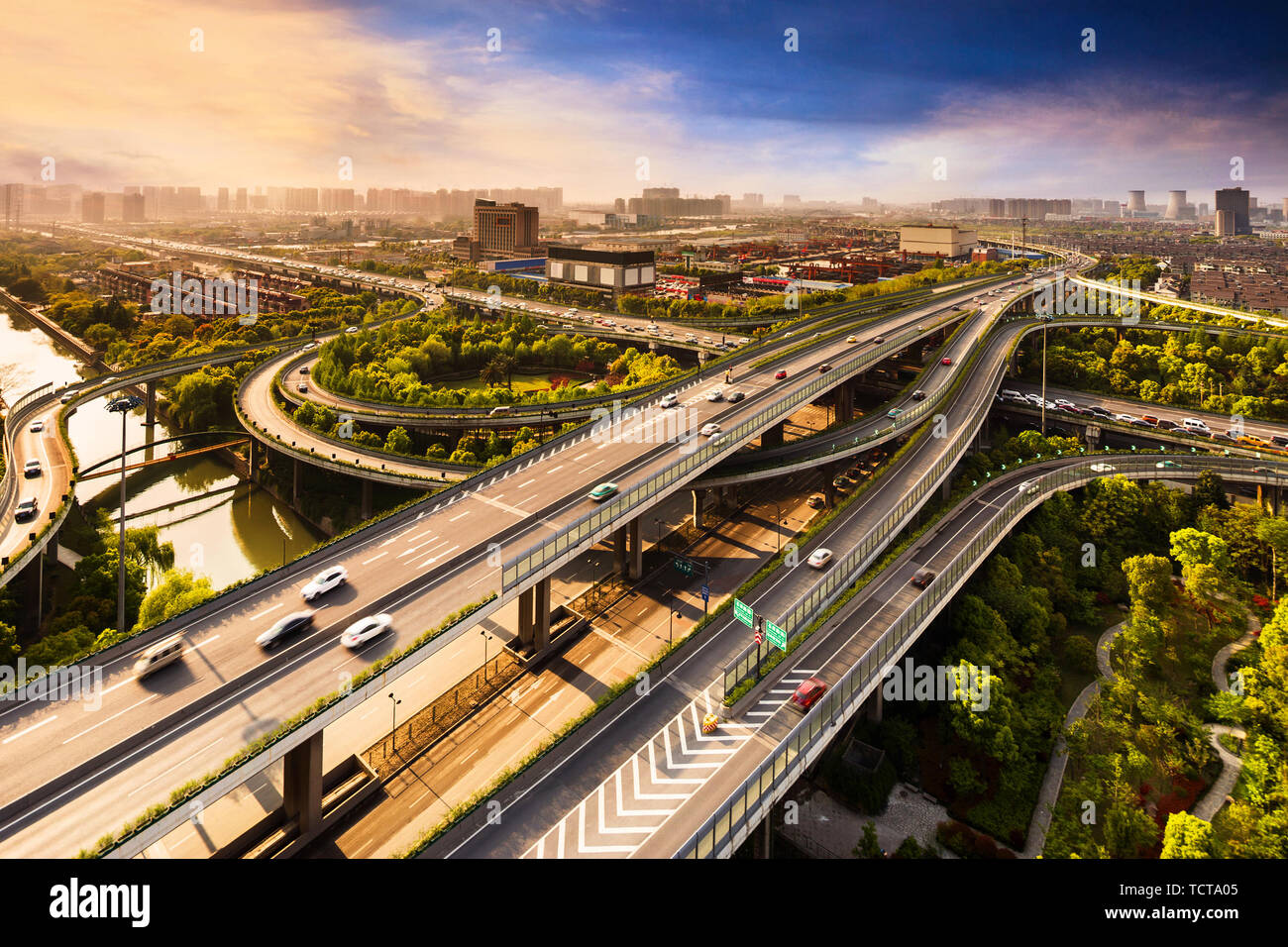 Elevated overpass with skyline of modern city during sunset Stock Photo ...