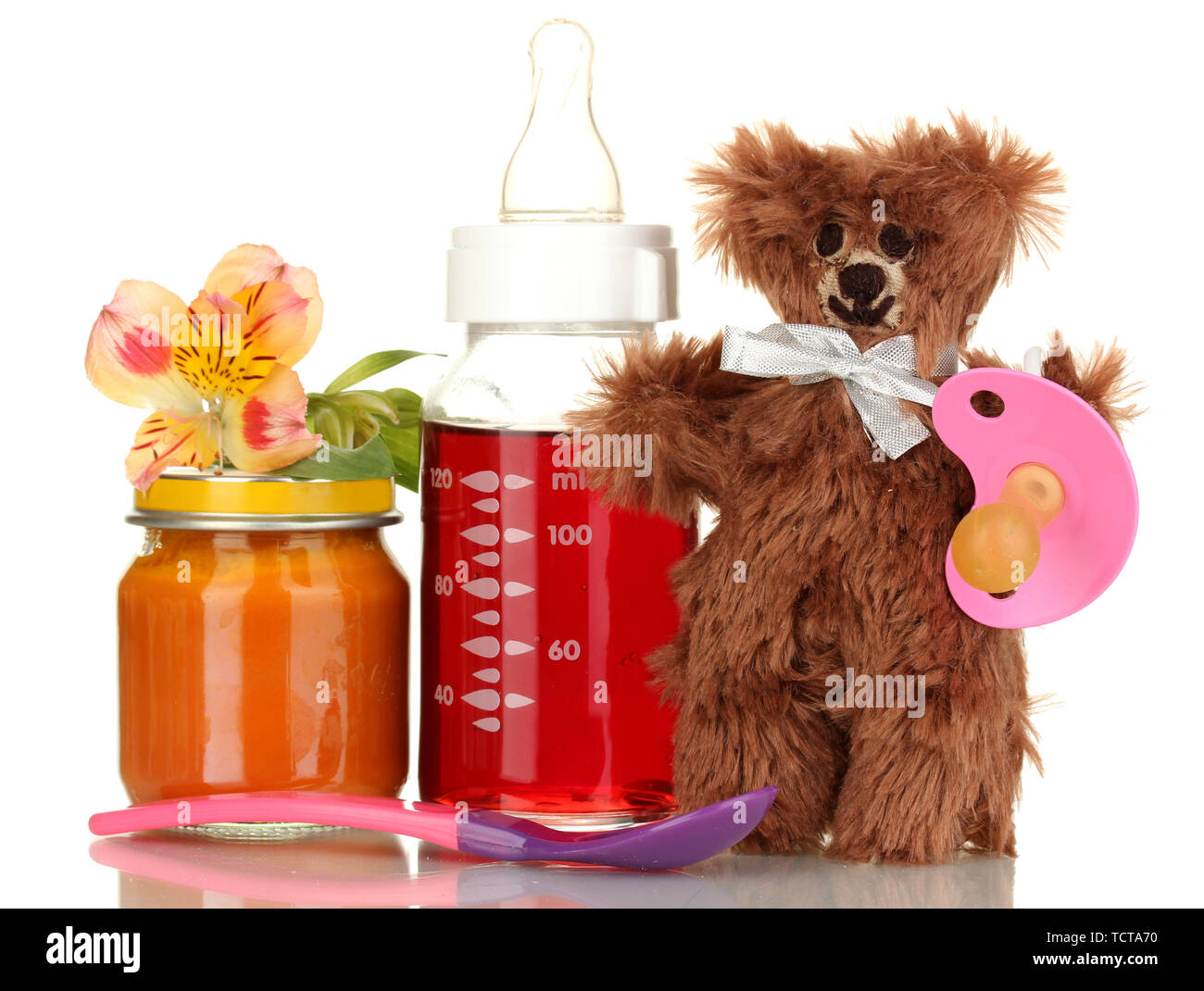Baby bottle with fresh juice, puree and teddy bear isolated on white ...