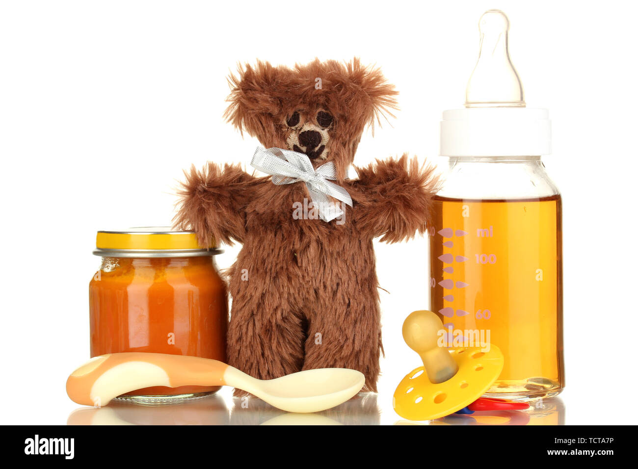 Baby bottle with fresh juice, puree and teddy bear isolated on white ...