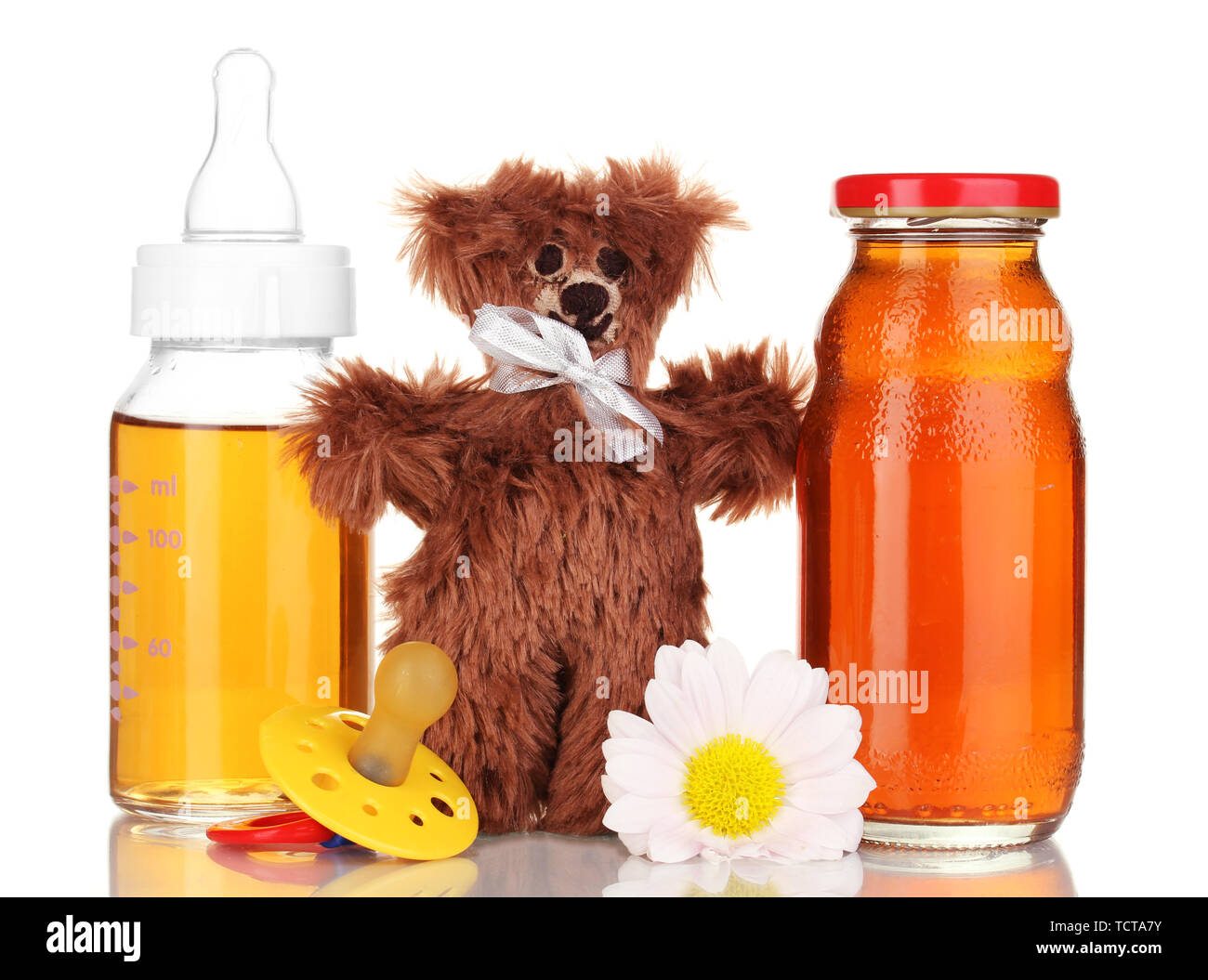 Baby bottle with fresh juice and teddy bear isolated on white Stock ...