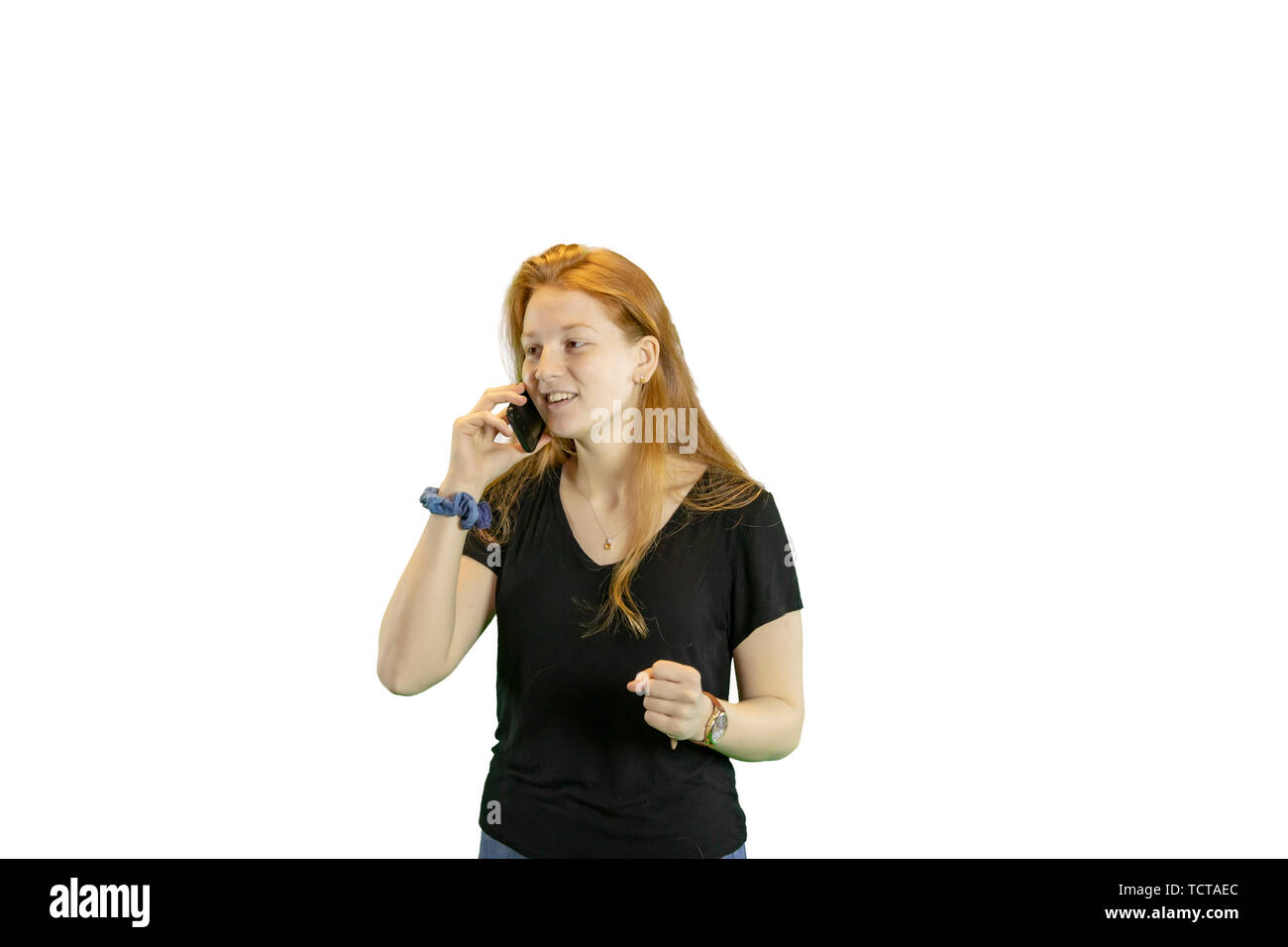 Teen girl with red hair talking on cell phone isolated on white with ...