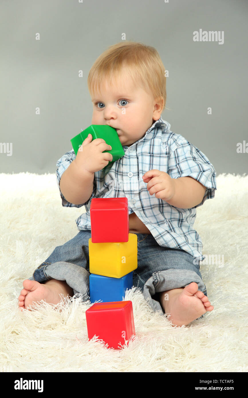Little boy playing with multicolor blocks Stock Photo - Alamy
